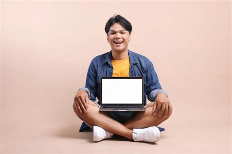 Premium Photo Happy Young Asian Man Sitting Cross Legged On The Floor With Blank Screen Laptop