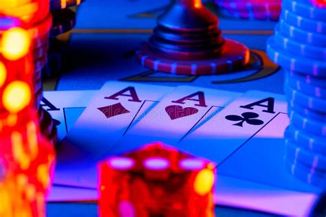 A Quad Of Four Aces Set Of Colored Chips And Dice On Gaming Table In