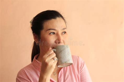 Asian Woman Drinking A Cup Of Coffee Or Tea In The Morning Stock Image Image Of Drinking