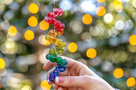 Brightly Colored Molecular Model Held Against A Bokeh Background Demonstrating An Artistic And