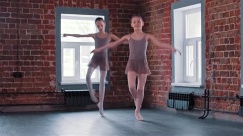 Two Ballerina Girls Synchronized Dancing In The Studio Stock Footage