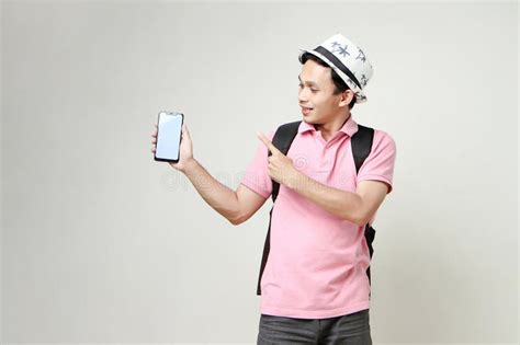 Asian Man Backpacker Showing Cellphone Blank Screen With Empty Space For Mobile App On Screen