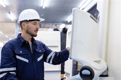 Man Engineer Using Computer Controlling Cnc Machine At Workshop