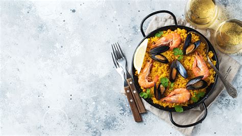 병아리콩 새우 홍합 밝은 회색 콘크리트 배경에 오징어와 팬에 전통적인 스페인 해산물 빠에야 복사 공간이 있는 상단 보기 0명에