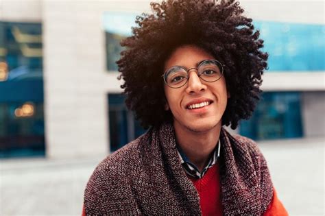Premium Photo Portrait Of Smiling Young Man Wearing Eyeglasses