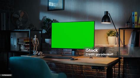 A Modern Personal Computer Monitor With Chroma Key Green Screen Display Standing On The Desk Of