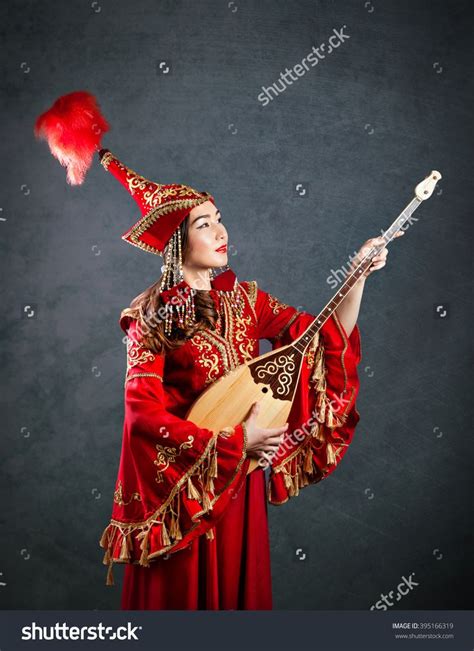 Traditional Kazakh Woman Playing Dombra In Vibrant Red Costume