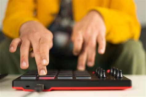 Premium Photo The Hands Of A Man Making Beats On His Mpd Midi Controller