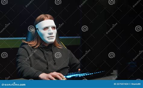 A Masked Hacker Girl Hacks A Database On A Computer Hacking It In A Dark Room Stock Footage