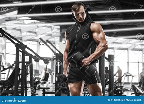 Muscular Man Working Out In Gym Doing Exercises Strong Male