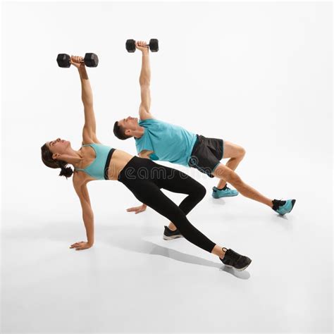 Sportive Young Man And Woman In Sportswear Doing Intensive Hard Plank