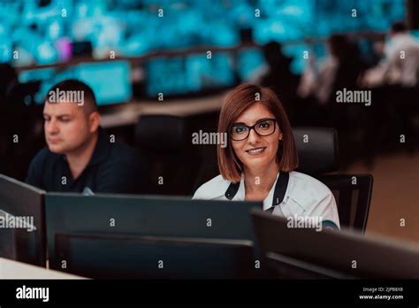 Female Security Operator Working In A Data System Control Room Offices Technical Operator