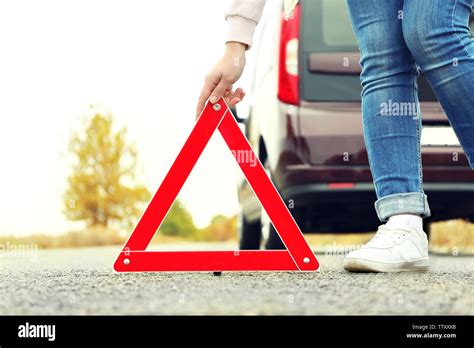 Female Driver Putting Out Traffic Warning Sign On Road Stock Photo Alamy