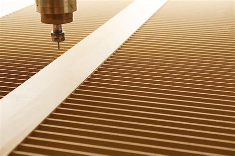 Premium Photo Numerically Controlled Woodworking Machine Cuts Complex Lines On The Canvas