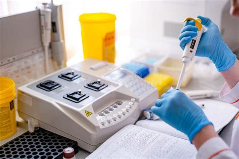 Modern Robotical Machine For Centrifuge Blood And Urine Testing Hands In Blue Latex Gloves Put