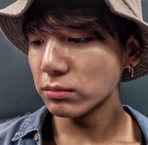 A Close Up Of A Person Wearing A Hat And Looking At The Camera With