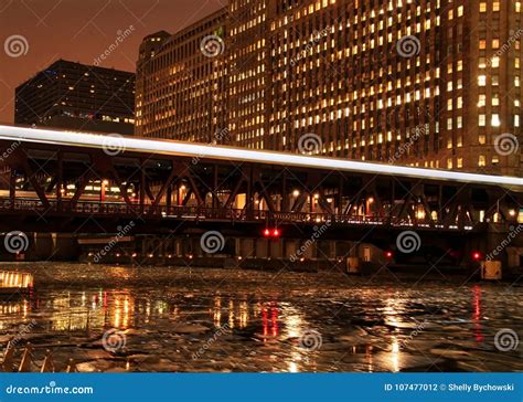City Night Lights Are Illuminated From Chicago Bridge And Moving El