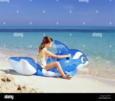 Girl On Inflatable Whale Stock Photo Alamy