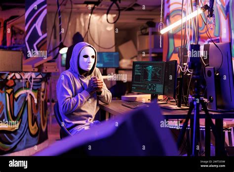 Anonymous Hacker Filming Scam Video On Mobile Phone While Doing Criminal Activity Scammer