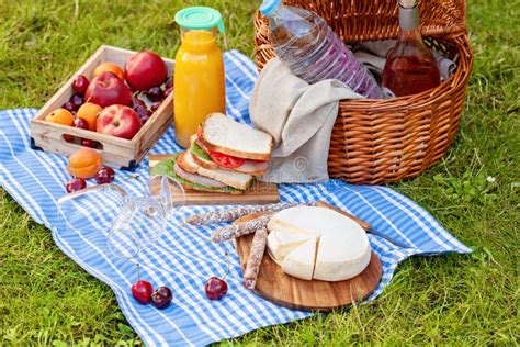 Picnic Basket With Different Snacks On The Green Grass Stock Image