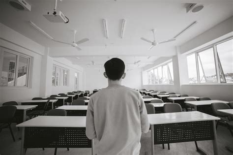Premium Photo Rear View Of Man Sitting Table In Classroom