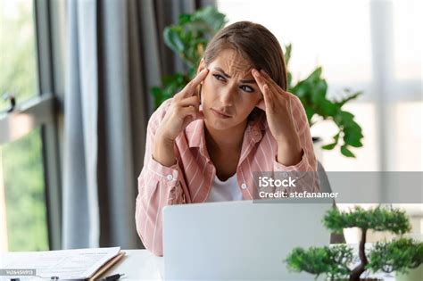 현대 사무실에서 두통을 앓고있는 지친 사업가 사무실 책상에서 일하는 창조적 인 여성이 피곤함을 느낍니다 데스크톱 컴퓨터에서 과로하는 동안 머리 통증을 느끼는 캐주얼 비즈니스