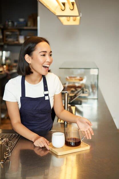 Premium Photo Smiling Asian Girl Barista Calling Client Giving Out Order In Cafe Prepared