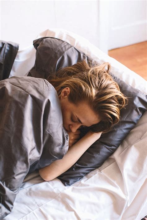 Sick Young Woman Sleeping In Bed By Stocksy Contributor Danil Nevsky