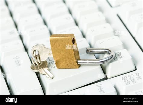 An Unlocked Padlock On Top A Computer Keyboard To Represent The Concept