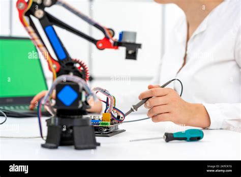 Model Of An Industrial Robot In A University Lab Women Measure Voltages