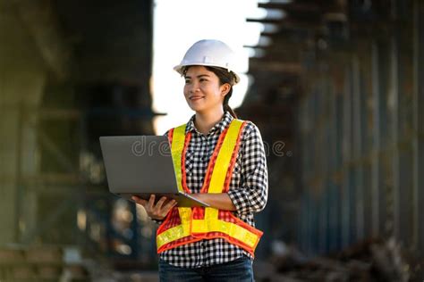 Asian Female Engineer Examining Structure Of Expressway With New