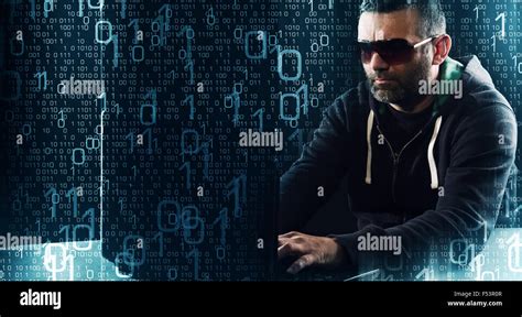 hacker typing on laptop computer keyboard binary code background stock