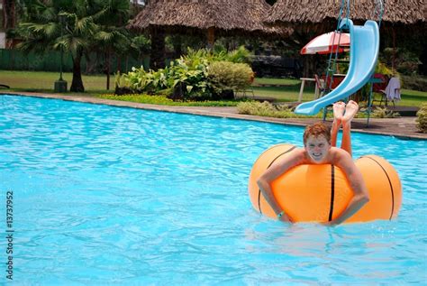 Handsome Babe Man On A Floating Device In The Pool Stock Photo Adobe Stock