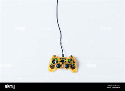 gamepad with cord on white wooden background view from above stock