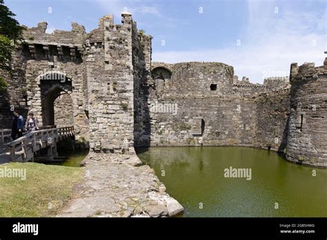 Tourists At Beaumaris Castle Walls And Moat A 13th Century Medieval