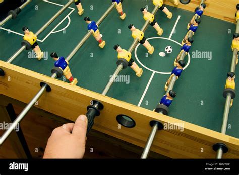 Hand Holds The Control Stick Of Toy Soccer Players While Playing Table