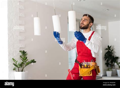 Electrician Mounting Ceiling Lamp Installing The Wires Stock Photo Alamy