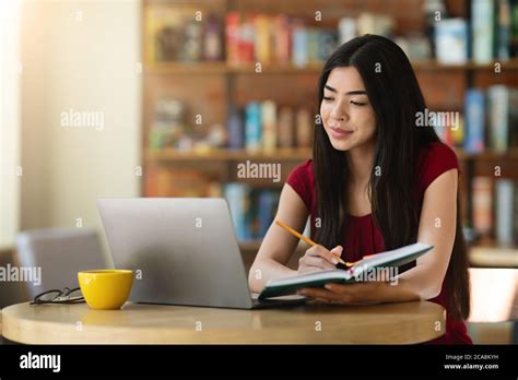 Online Education Korean Girl Studying With Laptop At Cafe And Taking