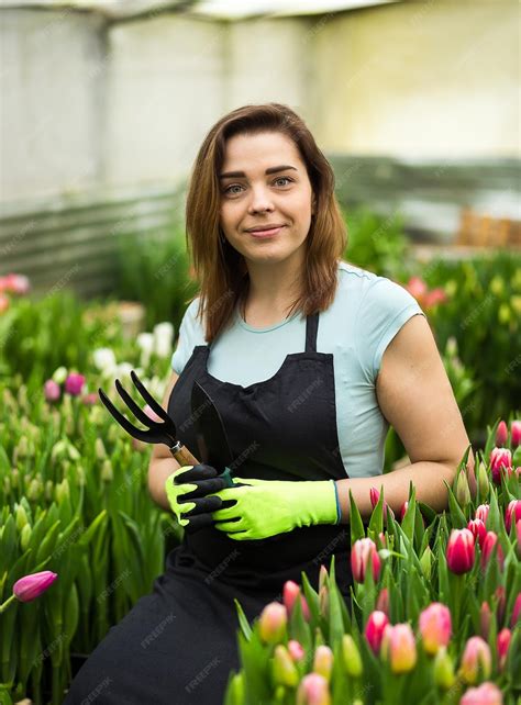 Premium Photo Woman Gardener With Garden Tools In The Greenhouse