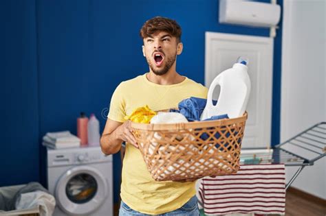 Arab Man With Beard Holding Laundry Basket And Detergent Bottle Angry