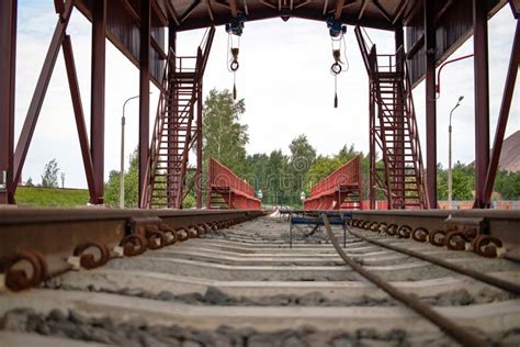 Loading And Unloading Platform For Railway Cars At An Industrial Site Featuring Cranes And