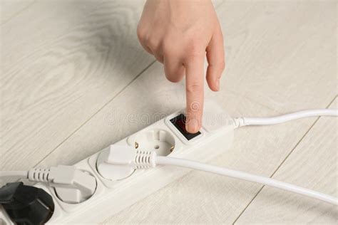 Woman Pressing Power Button Of Extension Cord On Floor Stock Image Image Of Electric Adapter