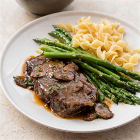 One Pot Braised Blade Steaks With Mushrooms Vidalias And Steamed Asparagus Americas Test