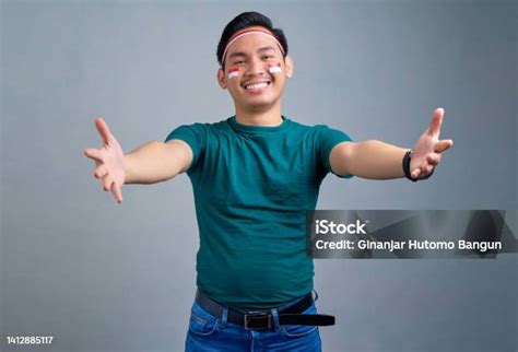 웃는 젊은 아시아 남자 회색 배경에 고립 된 포옹을 위해 뻗은 손으로 서있다 인도네시아 독립 기념일 축하 개념 30 34세에 대한 스톡 사진 및 기타 이미지 Istock