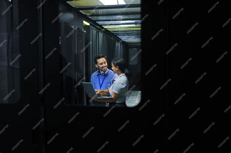 Premium Photo Man Woman Or Laptop In Server Room It Engineering Or Software Programming For