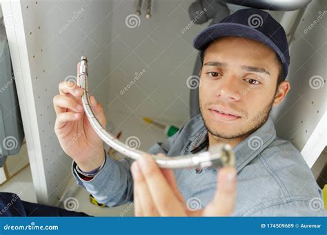 Hispanic Plumber Working Under Sink Stock Image Image Of Smiling