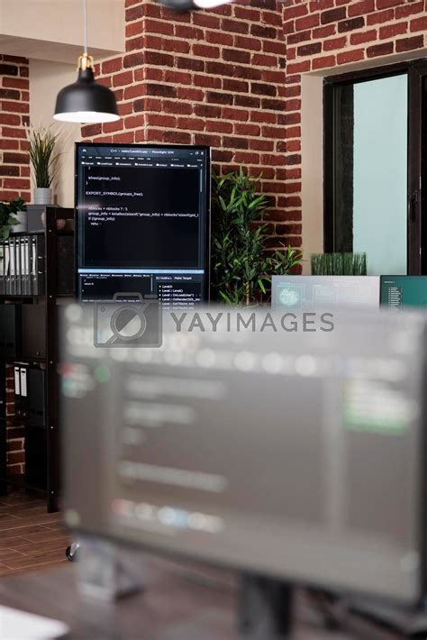 Interior Of Empty Data Center Office With Multiple Computer Screens Showing Programming Line