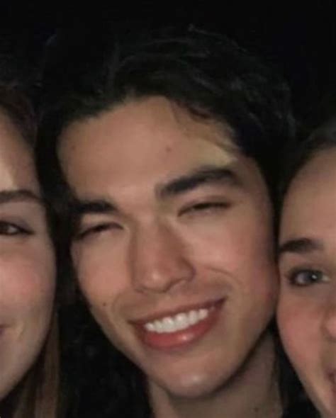 Three Young People Are Smiling For The Camera