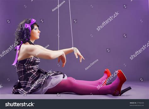 Woman Puppet On A String Sitting On A Stage Over 4 Royalty Free Licensable Stock Photos