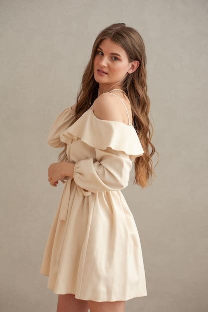 Premium Photo Woman Wearing A Light Brown Dress With Ruffles And A